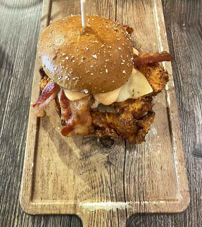 That fried chicken sandwich sitting pretty on a sesame bun like it just won the lottery and knows it.