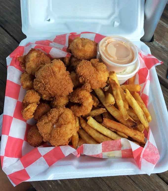 Golden fried scallops and shrimp piled high in a basket prove that sometimes the best things come in checkered paper.