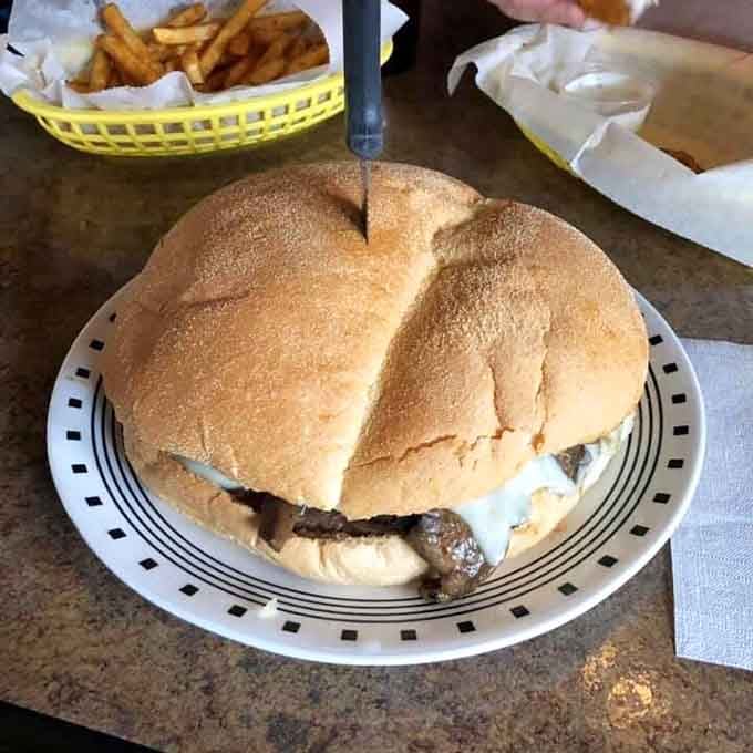 The Mushroom Swiss towers like a delicious skyscraper, making regular burgers look like architectural failures by comparison.