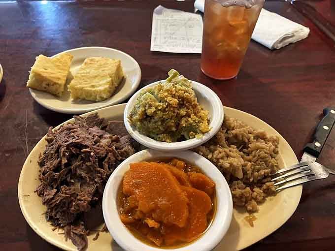Tender roast beef surrounded by Southern sides that look like they came straight from someone's beloved family recipe collection.