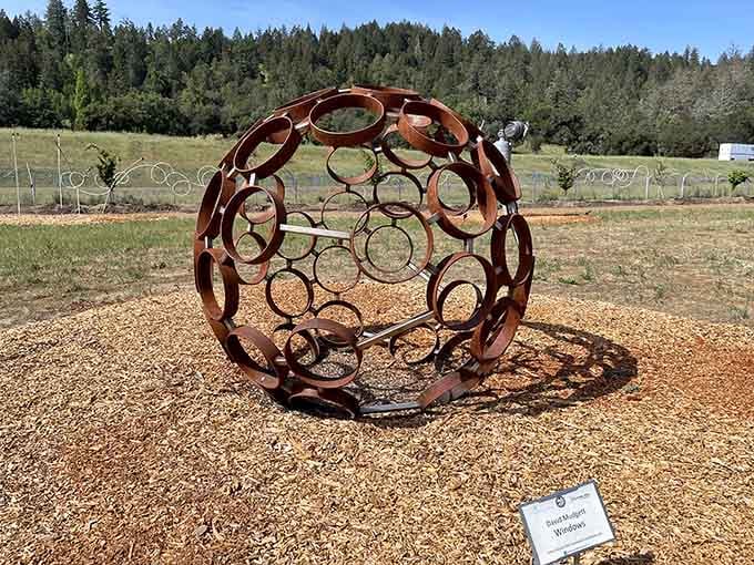 Geometry meets geometry in this spherical wonder, where circles within circles create shadows that dance across the gravel.