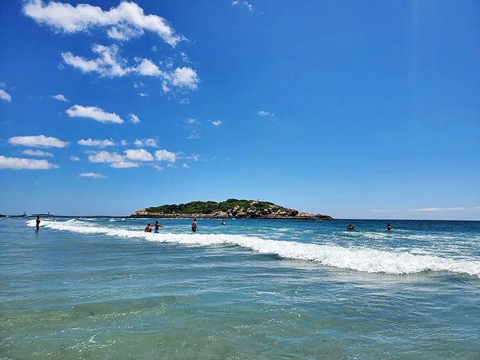 Salt Island beckons in the distance while beachgoers enjoy waves perfect for bodysurfing without requiring a wetsuit and courage.