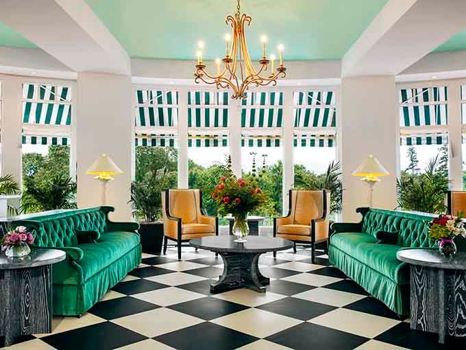 Emerald green tufted sofas and mint ceiling create a color palette your grandmother would absolutely approve of with delight.