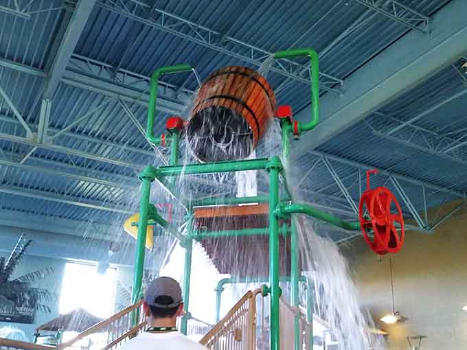 That giant bucket fills slowly, building suspense before dumping gallons of pure joy on delighted victims below.