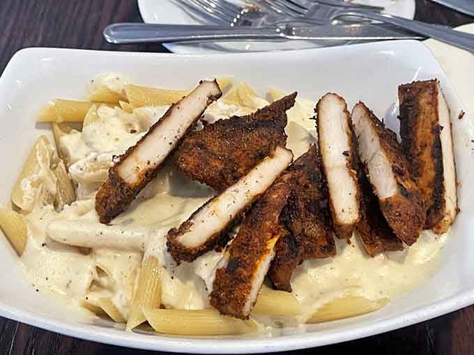 Cajun pasta loaded with blackened chicken proves this kitchen doesn't play favorites between land and sea options.