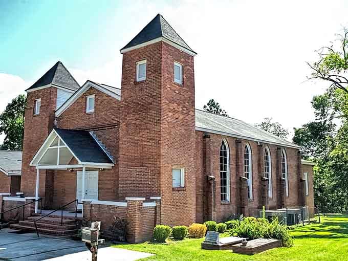 First Providence Baptist Church maintains its dignity with fresh brick and careful landscaping, proving some things refuse to surrender to time.