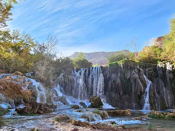 Navajo Falls cascades over travertine like nature's own fountain show, minus the Vegas ticket prices and crowds.