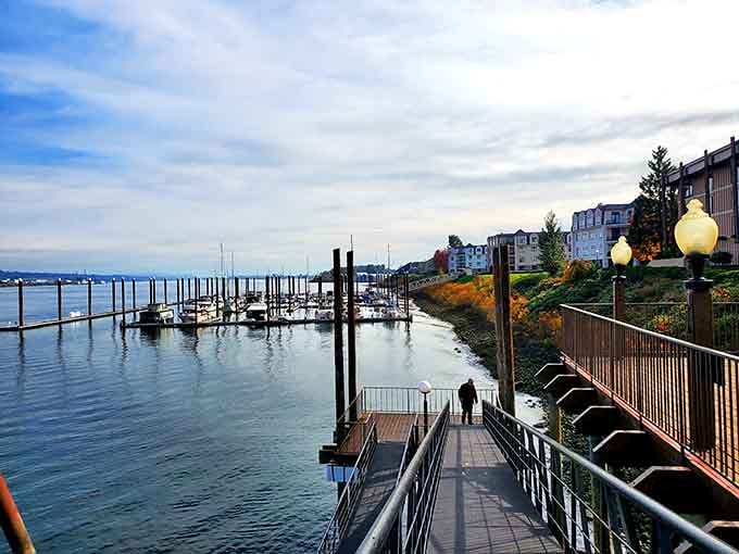 The marina's wooden docks stretch into calm waters, where boats bob gently and worries drift away downstream.