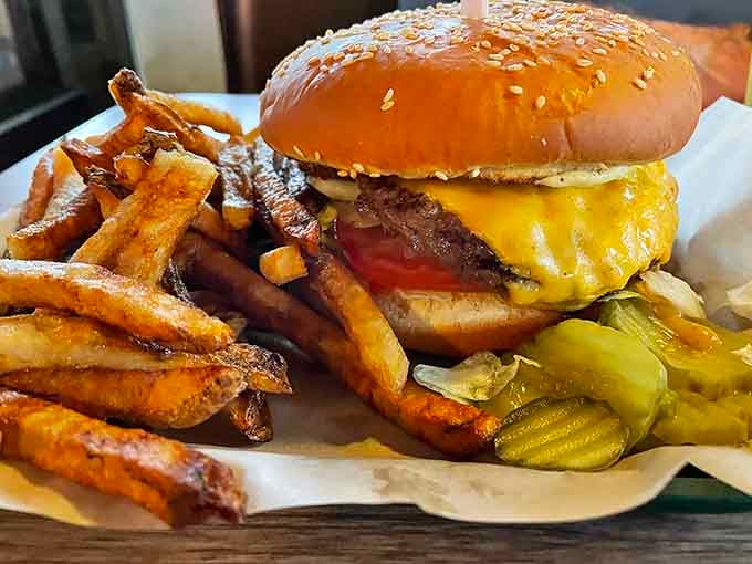That sesame seed bun is working overtime holding together this glorious tower of beef and cheese.