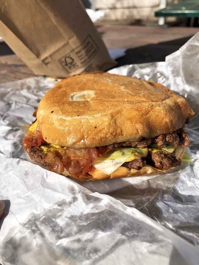 That golden bun glistening with burger juice and bacon peeking out is what food dreams are made of.