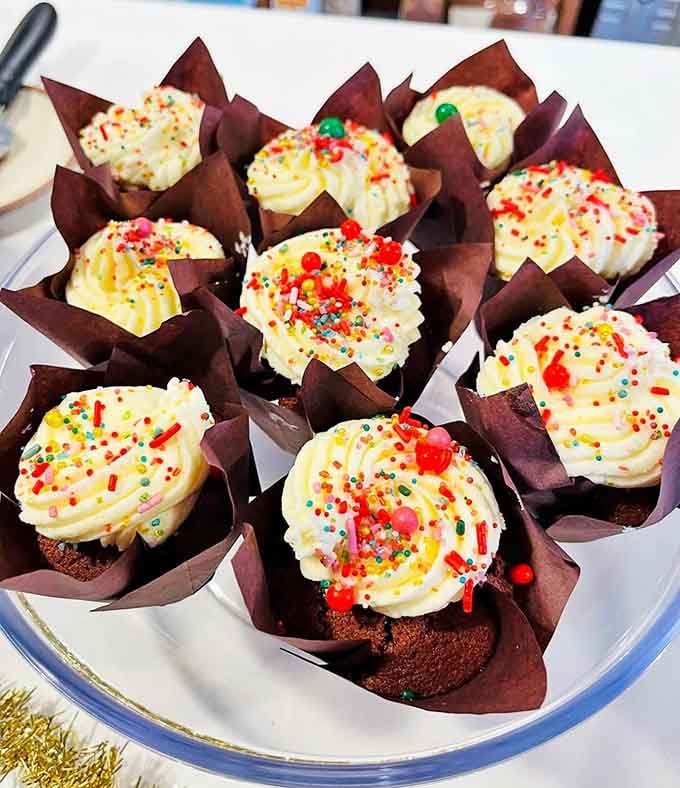Cupcakes topped with swirls of buttercream and rainbow sprinkles, because adulthood means eating dessert whenever you want.