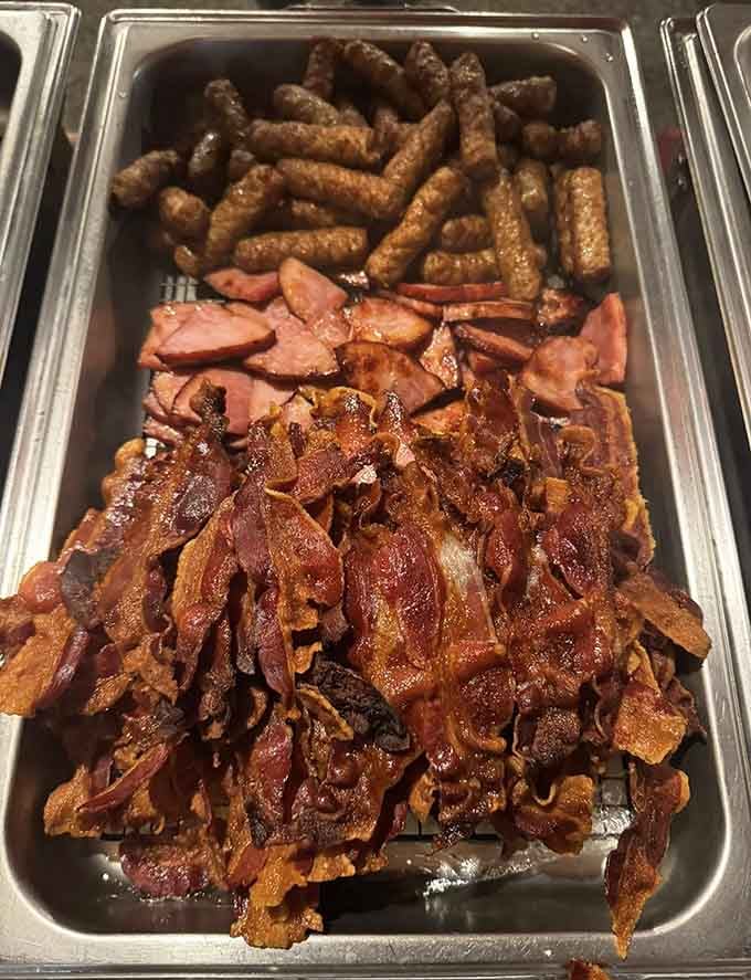 The holy trinity of breakfast meats, glistening and ready to make your cardiologist mildly concerned.