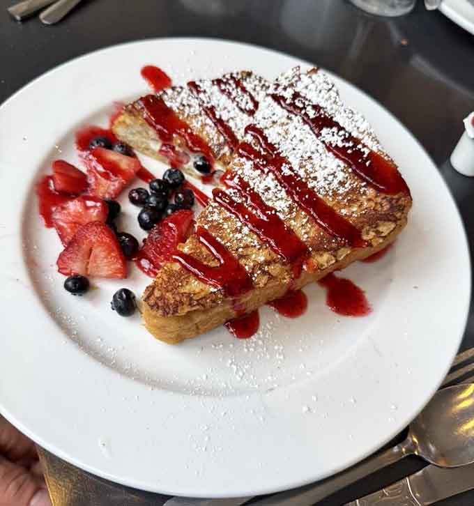 French toast dressed up with fresh berries and raspberry drizzle, because sometimes breakfast deserves to wear its Sunday best.