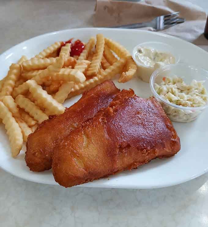 Golden fried fish with crinkle fries proves comfort food doesn't need fancy plating to taste absolutely magnificent.