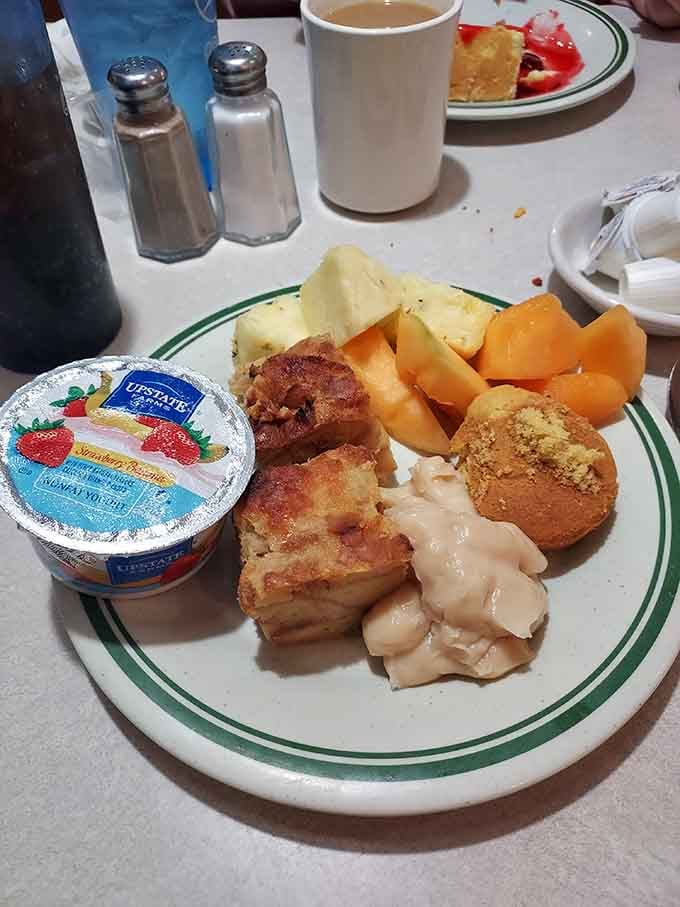 Fresh fruit, tender chicken, and cornbread muffins make this breakfast plate look like a Norman Rockwell painting come to life.