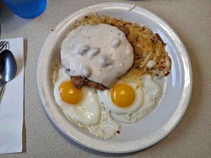 Country fried steak smothered in gravy with eggs and hash browns, because subtlety is overrated at breakfast.