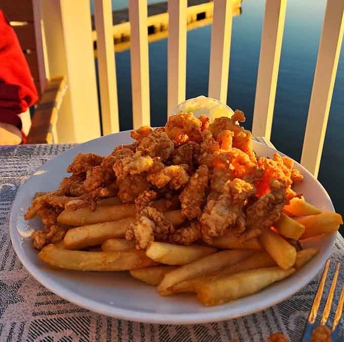 Fried clams piled high enough to require architectural support, because moderation is overrated at the beach.