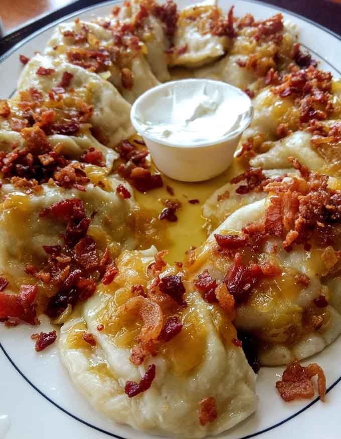 Loaded pierogis arranged like edible art, swimming in butter and bacon because sometimes more really is more.