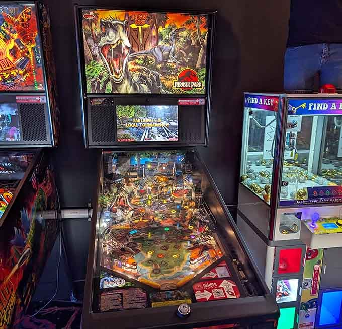 A Jurassic Park pinball machine sits ready to devour quarters with the same enthusiasm as its namesake.