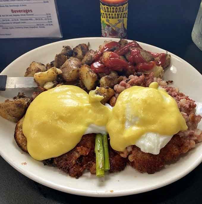 Eggs benedict with perfectly golden hollandaise sauce, served alongside home fries that know their purpose in life.