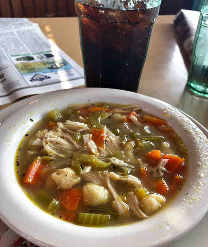 Fresh vegetables and tender dumplings float in golden broth that tastes like a warm Wisconsin hug.