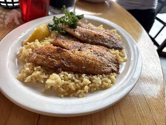 Golden-crusted tilapia resting on seasoned rice is simple done spectacularly, like Sinatra singing standards.