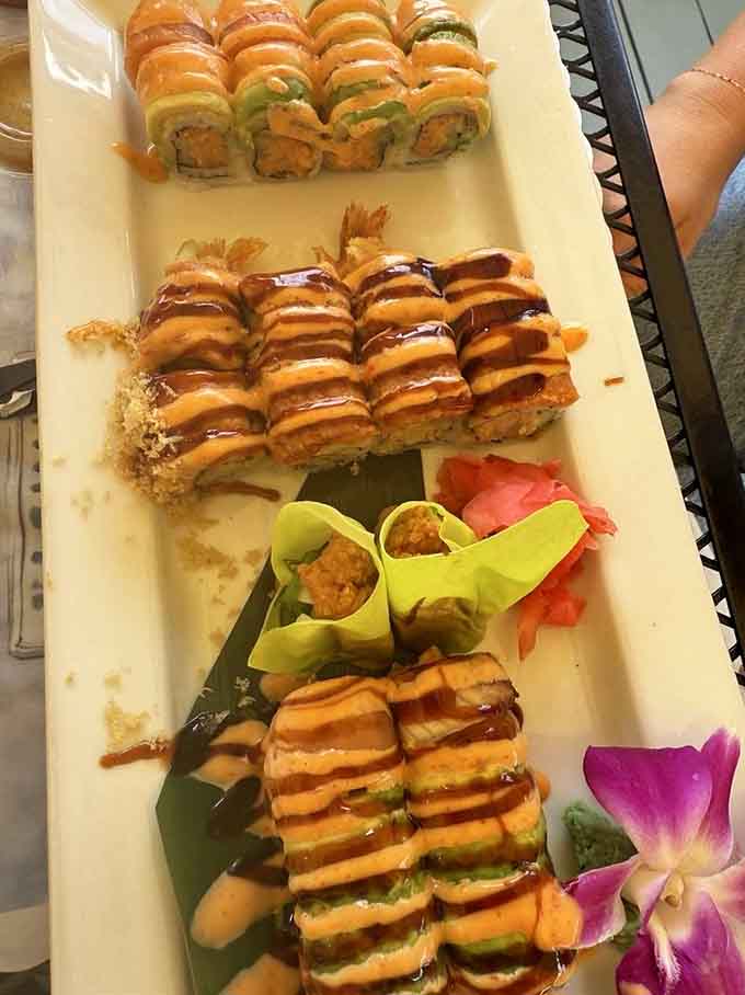 These sushi rolls arrive looking like edible art, drizzled with sauce and garnished prettier than most restaurant desserts.