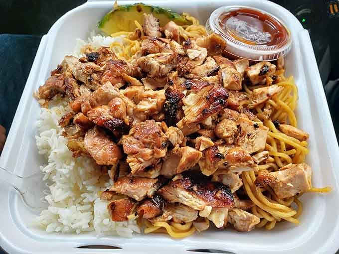 Tender chicken piled high over noodles and rice, because choosing between carbs is for quitters.