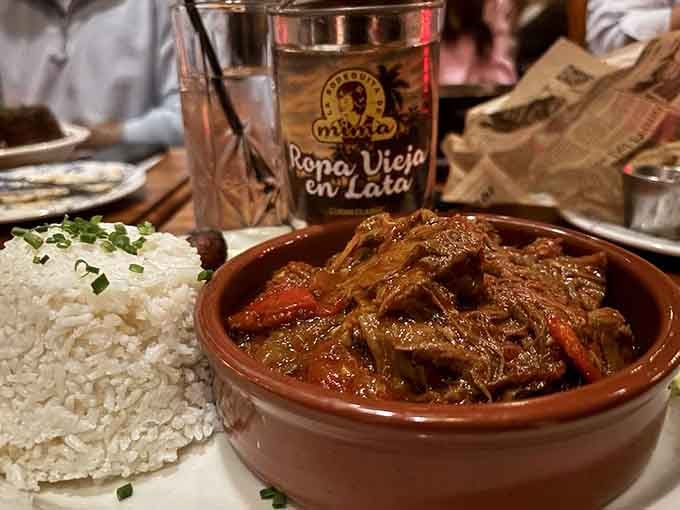 Ropa Vieja arrives in its own pot like a treasure chest, revealing tender beef swimming in tomato perfection.