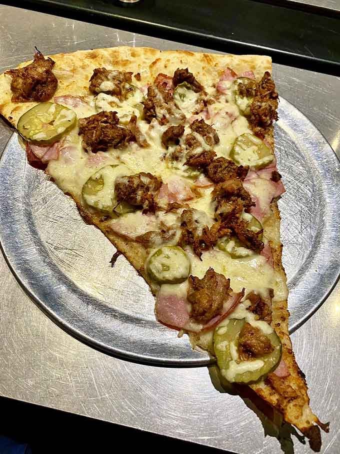 Cuban flavors meet pizza engineering in this pickle-topped wonder that stretches the definition of handheld food.