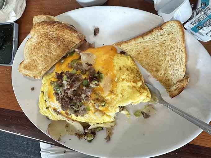 A farm omelet so generously stuffed, it practically needs its own zip code and mailing address.