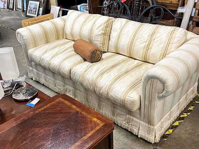 This striped beauty with fringe detailing screams vintage elegance, just waiting for its second act in someone's living room.