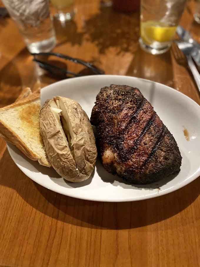 The NY strip arrives with a baked potato that's practically begging you to load it up with everything.