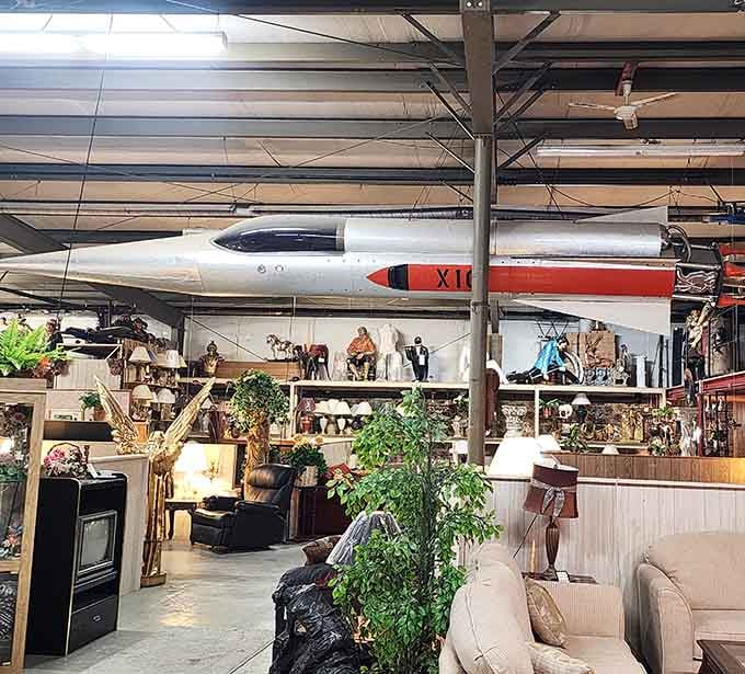 Furniture, lamps, and a sleek boat overhead prove that vertical space is just another opportunity for visual magic.