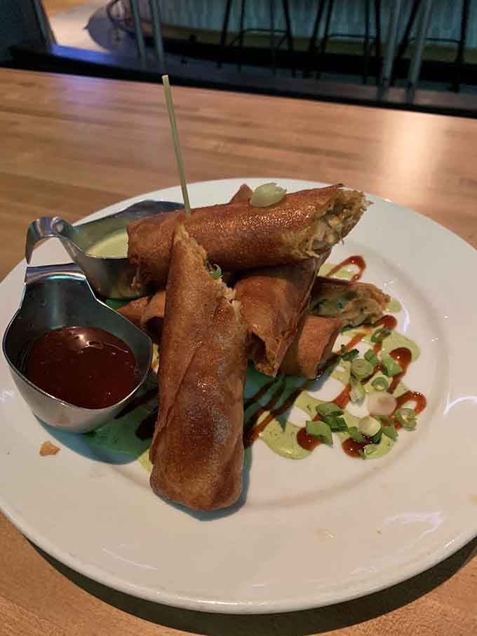 Golden, crispy perfection stacked high with dipping sauces standing guard, ready to transform your entire understanding of bar appetizers forever.