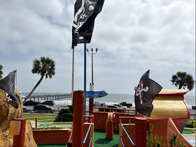 Pirate flags waving over the greens because apparently even buccaneers needed to work on their short game.