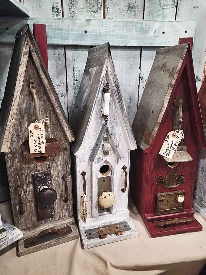 These weathered birdhouses built from reclaimed wood and vintage hardware belong in a folk art museum, not your backyard.