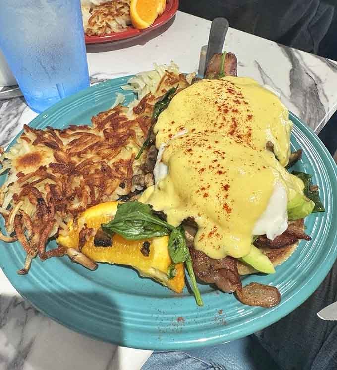 That hollandaise cascade over poached eggs is basically edible sunshine, and those hash browns aren't playing around either.
