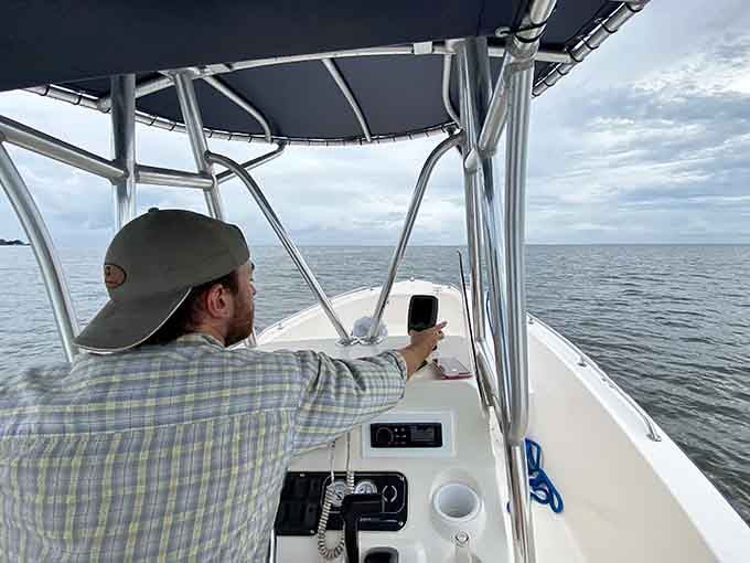 Gliding across Mobile Bay, the lighthouse ahead feels like a quiet welcome, guiding a peaceful ride under soft skies and gentle waters.