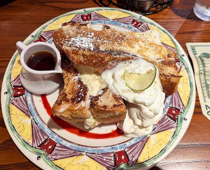 French toast so decadent it makes dessert jealous, topped with enough powdered sugar to make Mary Poppins proud.