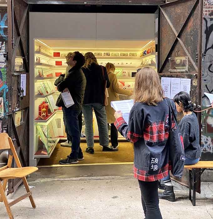 The crowd gathers at this elevator shaft like it's opening night on Broadway, only smaller and infinitely more intriguing.