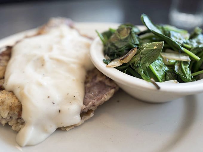 Chicken fried steak draped in gravy with a side of greens, because vegetables count when they're this delicious.