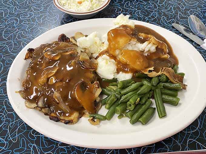 Chopped sirloin with gravy, mashed potatoes, and green beans: comfort food that actually comforts your soul properly.