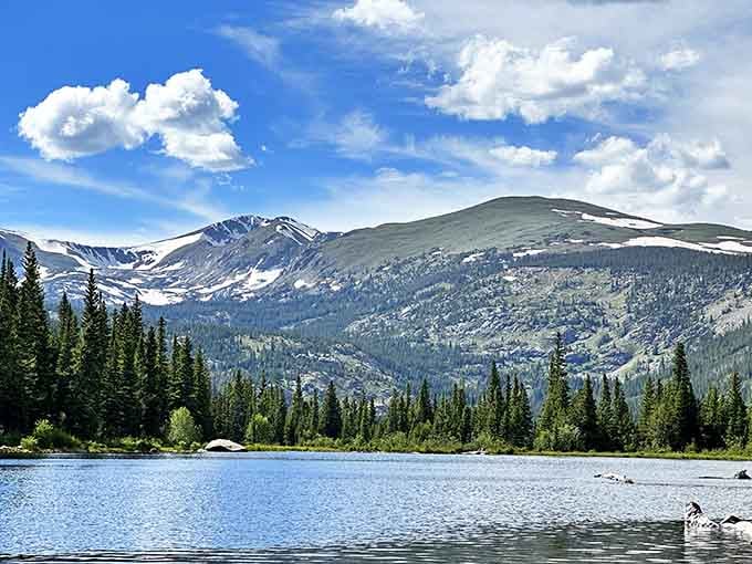 Crystal-clear alpine waters mirror the peaks above, creating postcard views that cameras somehow never quite capture properly.