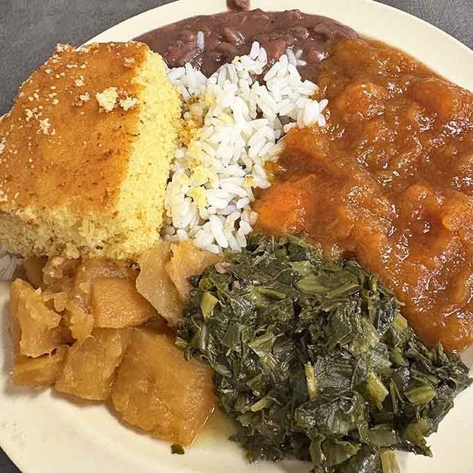 Cornbread so perfect it crumbles just right, surrounded by collards, beans, and gravy begging for your attention.