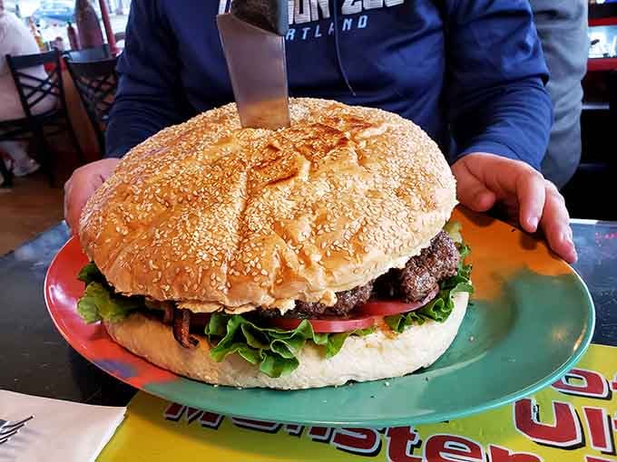 That sesame seed bun is working harder than a suspension bridge, holding together layers of beefy, melty perfection.