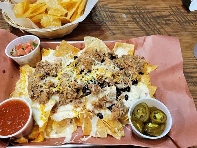 Loaded nachos piled high with pulled pork, cheese, and jalape&ntilde;os make sharing an exercise in willpower and negotiation.