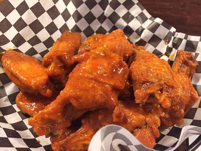 Buffalo wings glistening with sauce like they just won the lottery and don't care who knows it.