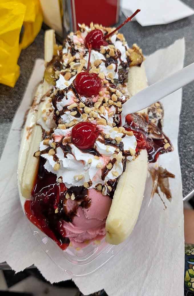 Behold the banana split in all its glory: three scoops, three sauces, and zero regrets about your life choices.