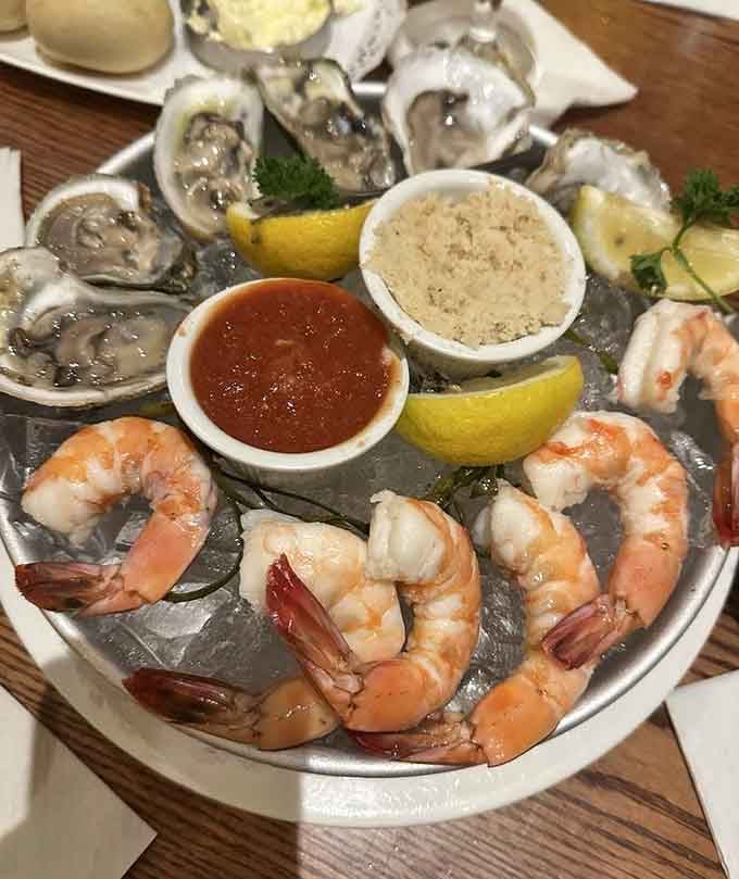 Fresh oysters and jumbo shrimp on ice: the ocean's greatest hits album, served on a silver platter.